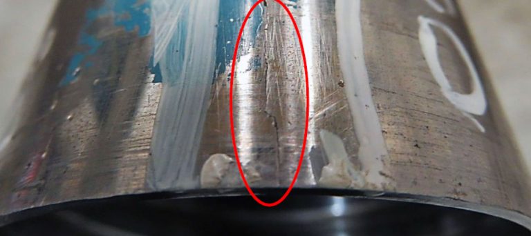 Axially oriented heat check crack and polished wear area - Boart Longyear